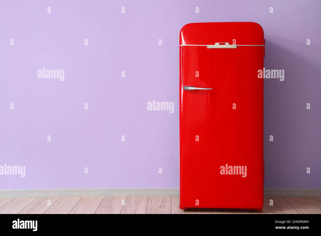 Red fridge near lilac wall Stock Photo - Alamy