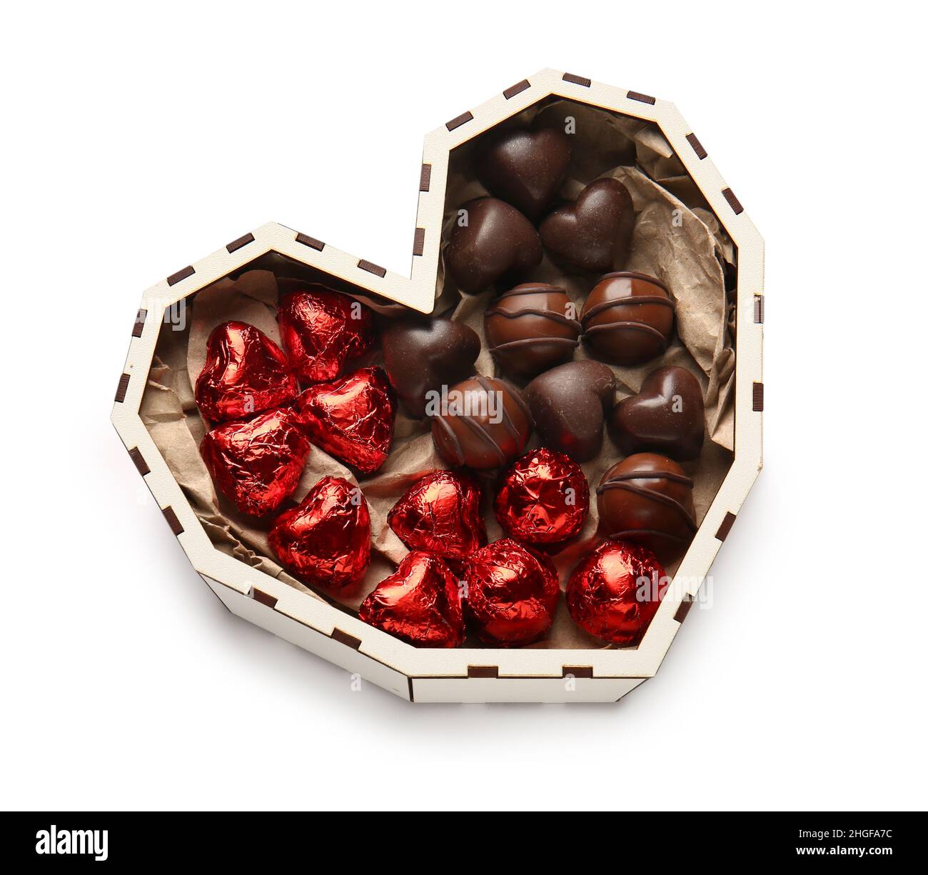 Heart shaped box with tasty chocolate candies isolated on white ...
