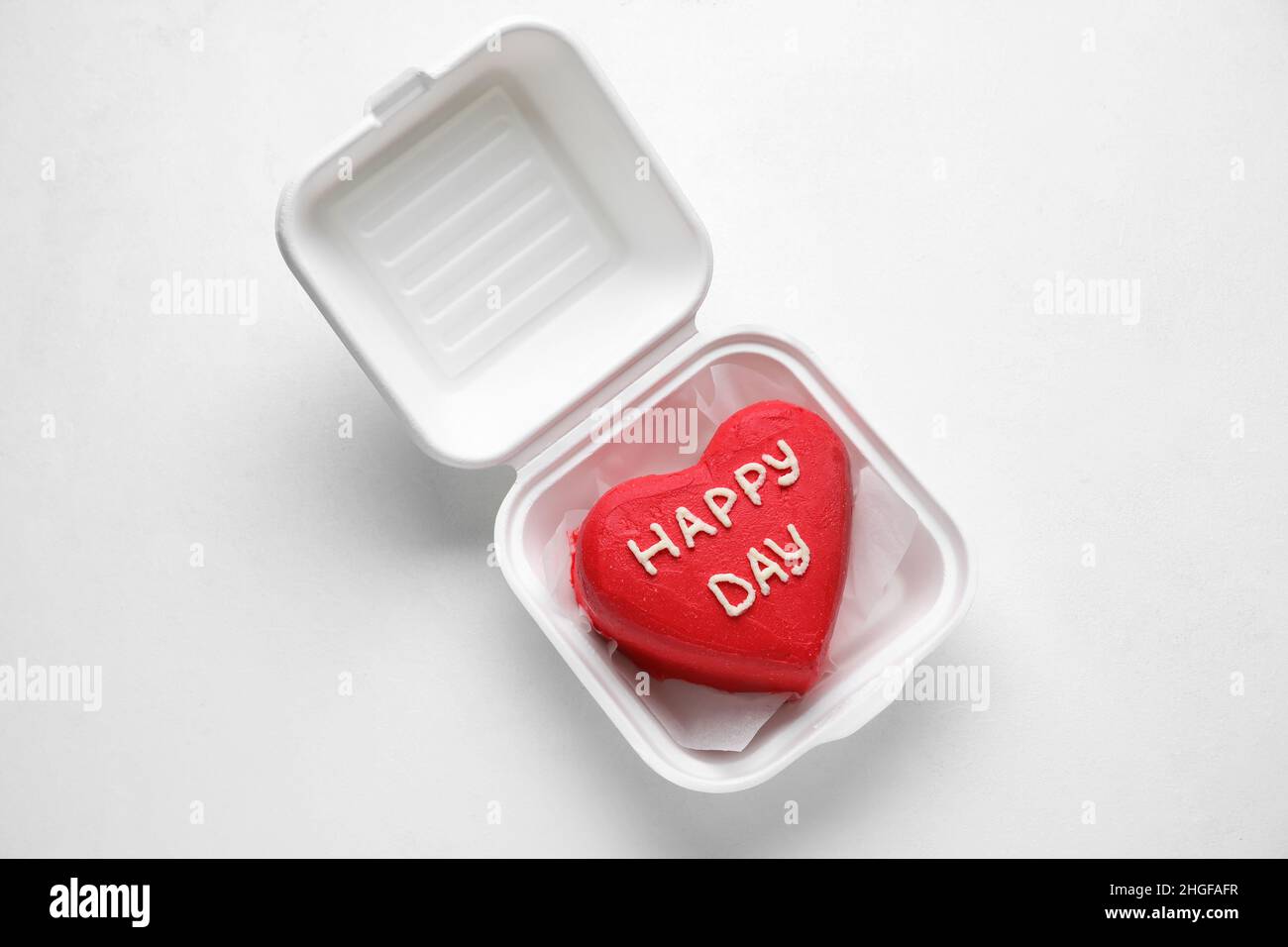 Plastic lunch box with tasty bento cake on white background Stock Photo ...
