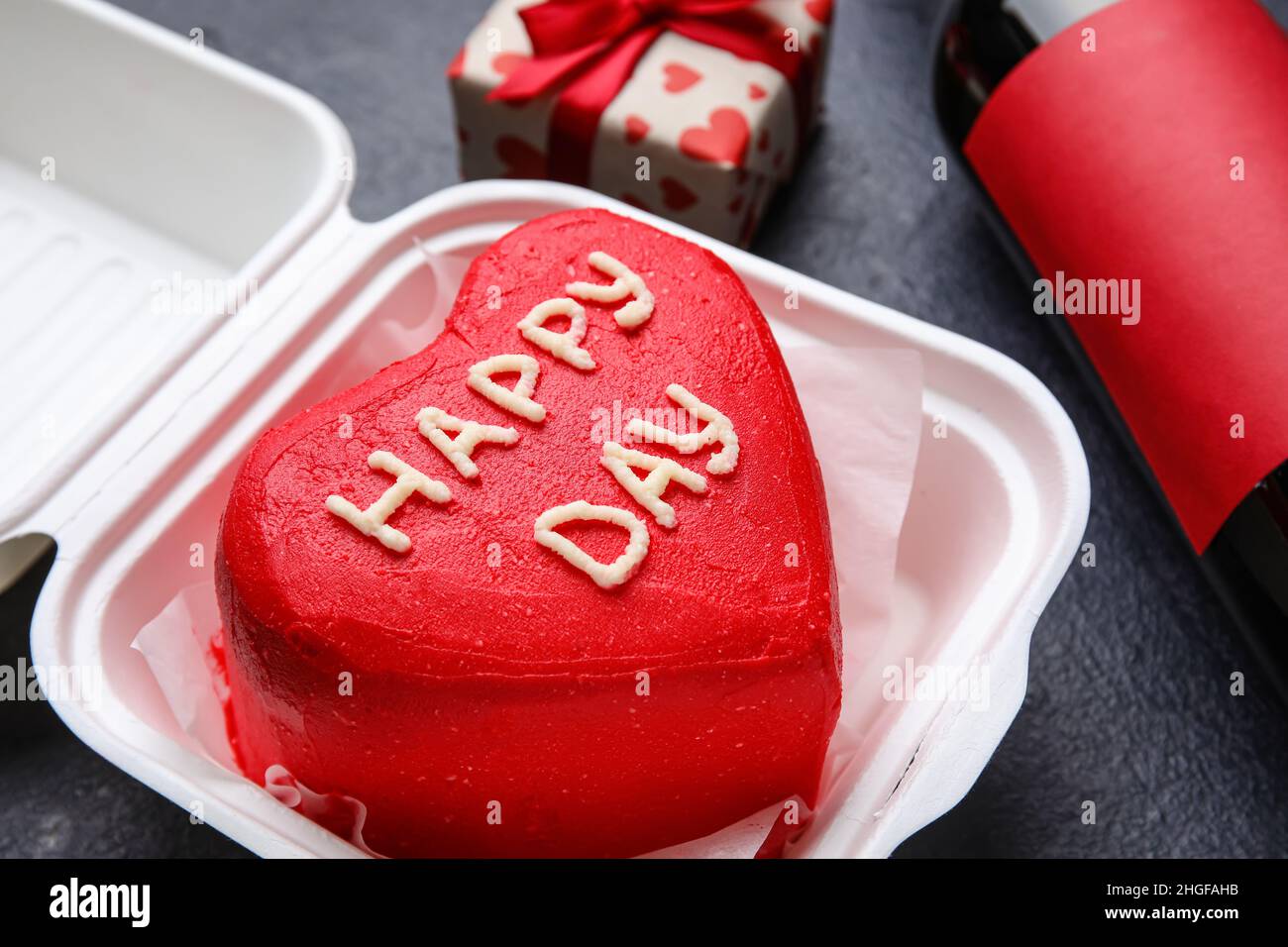 Plastic lunch box with tasty bento cake on dark background, closeup ...