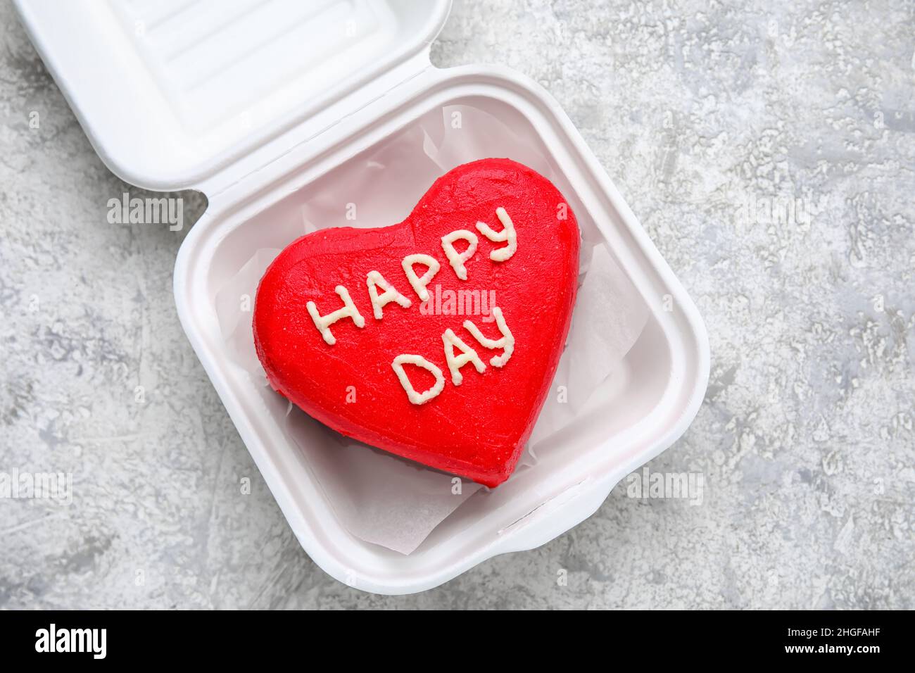 Plastic lunch box with tasty bento cake on light background Stock Photo ...