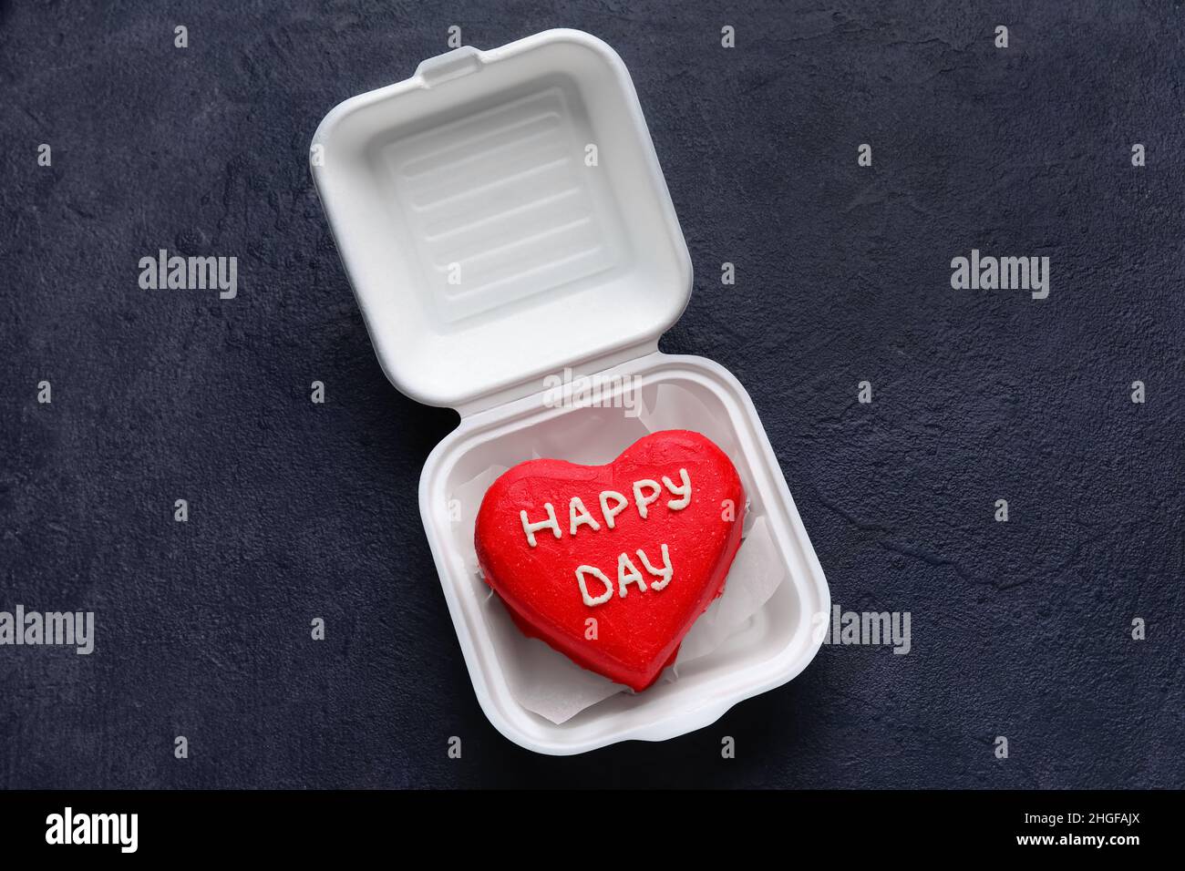 Plastic lunch box with tasty bento cake on dark background Stock Photo ...