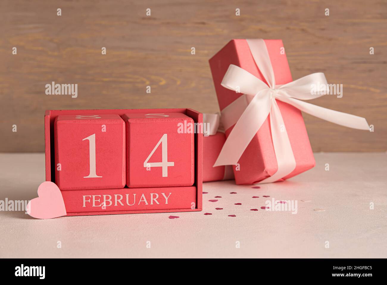 Calendar with date of Valentines Day and gift boxes on table Stock ...