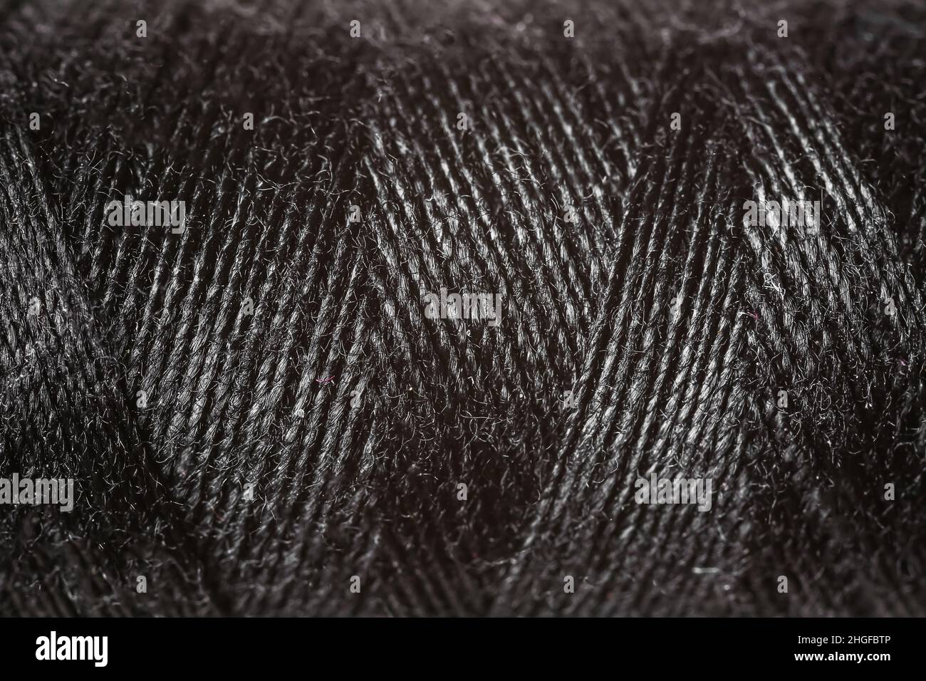 Black sewing threads as background Stock Photo - Alamy
