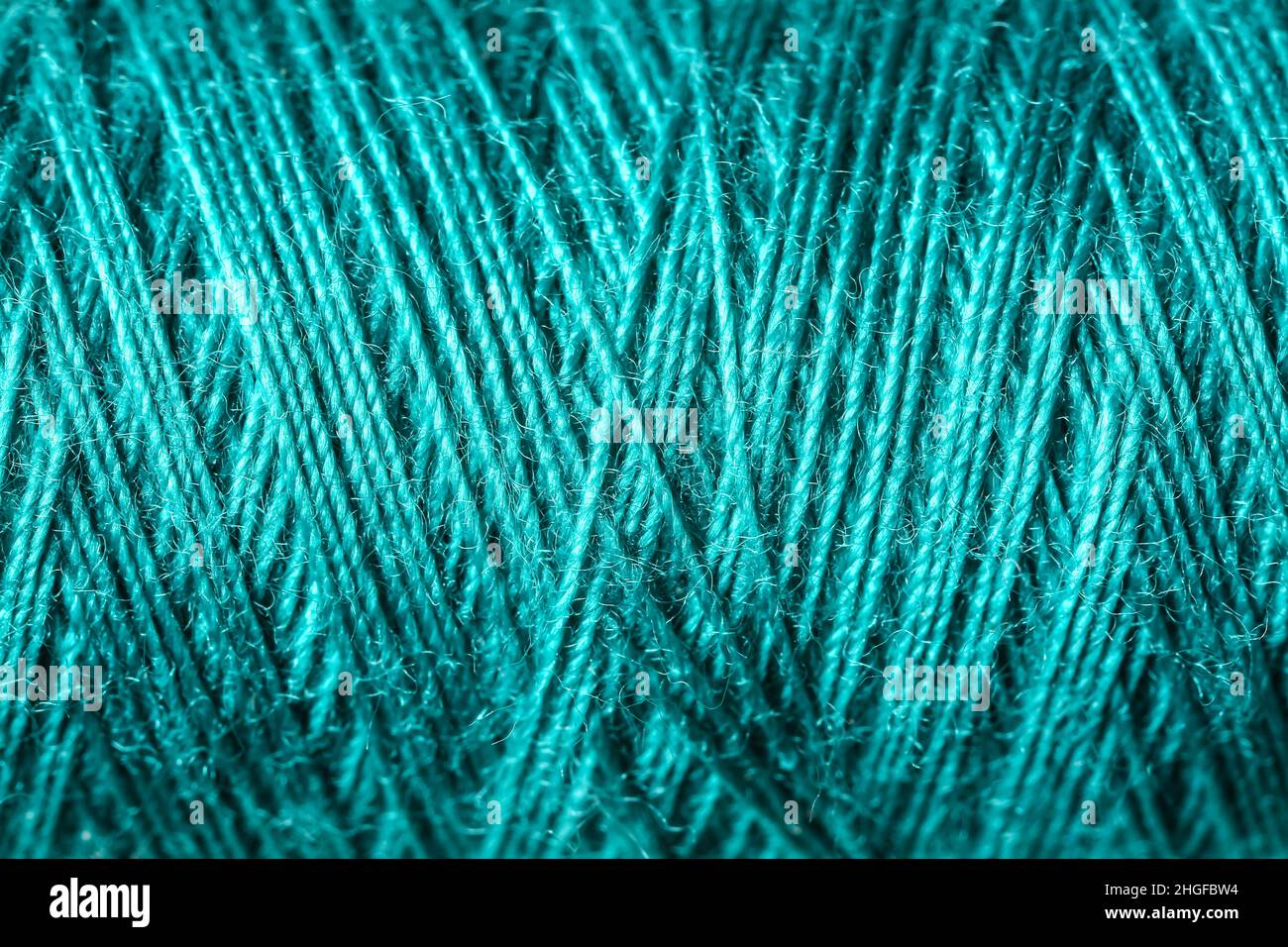 Turquoise sewing threads as background Stock Photo - Alamy