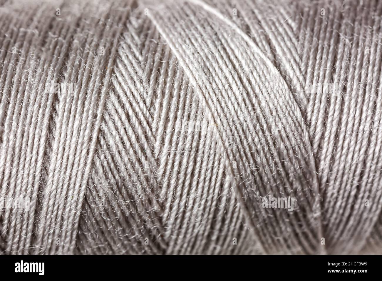 Grey sewing threads as background Stock Photo - Alamy