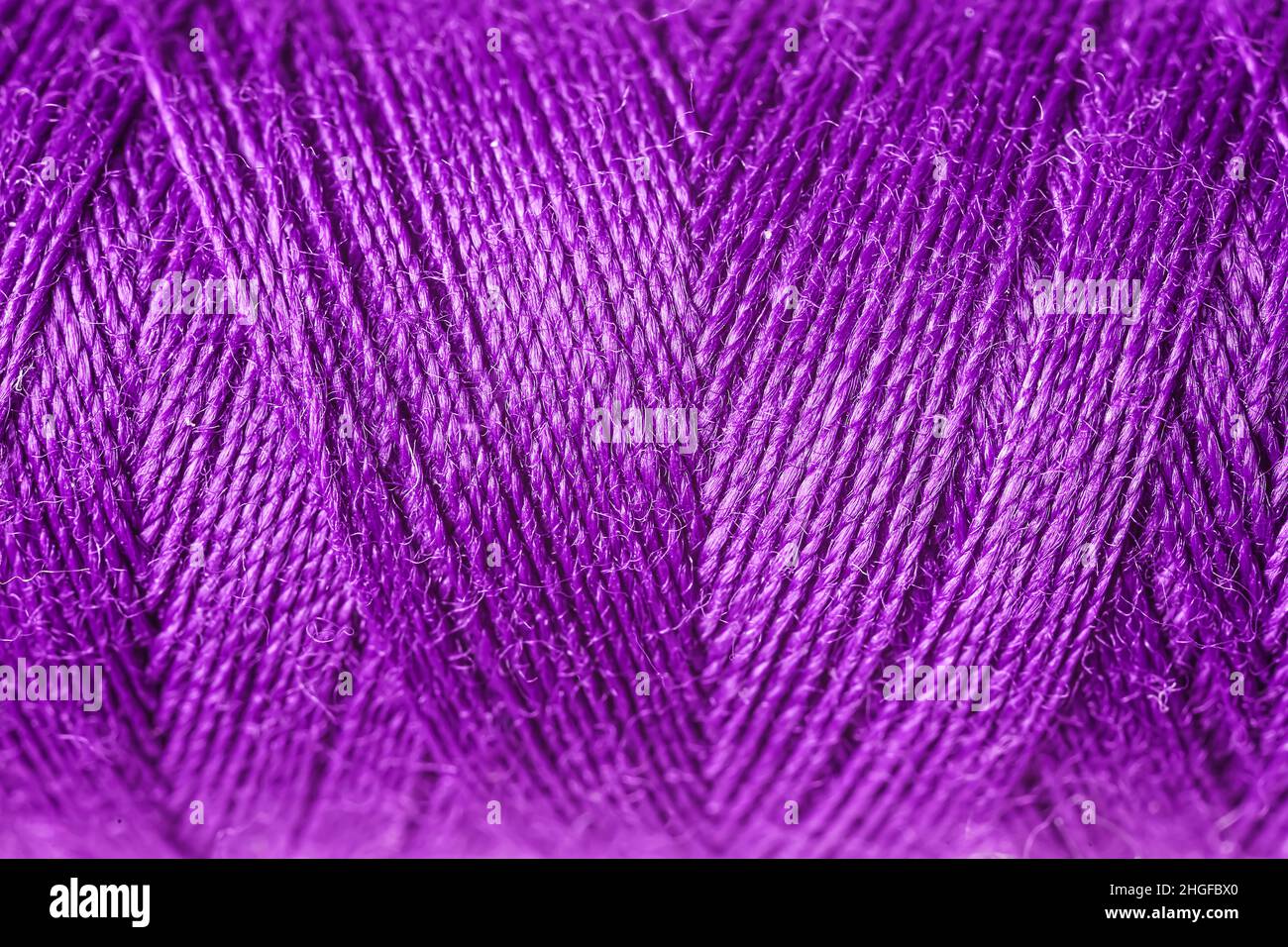Purple sewing threads as background Stock Photo - Alamy