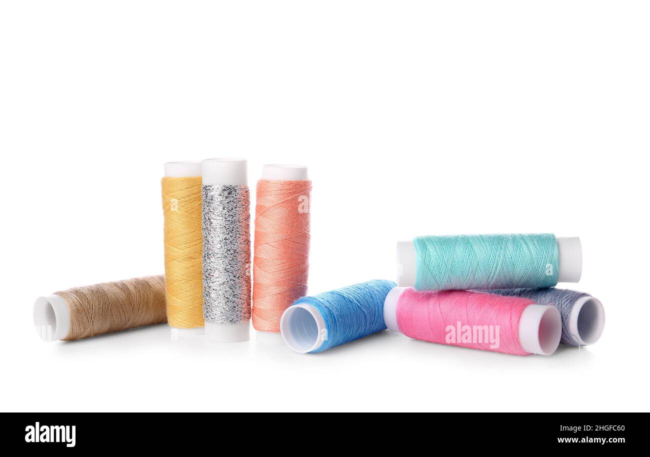 Different sewing thread spools on white background Stock Photo - Alamy