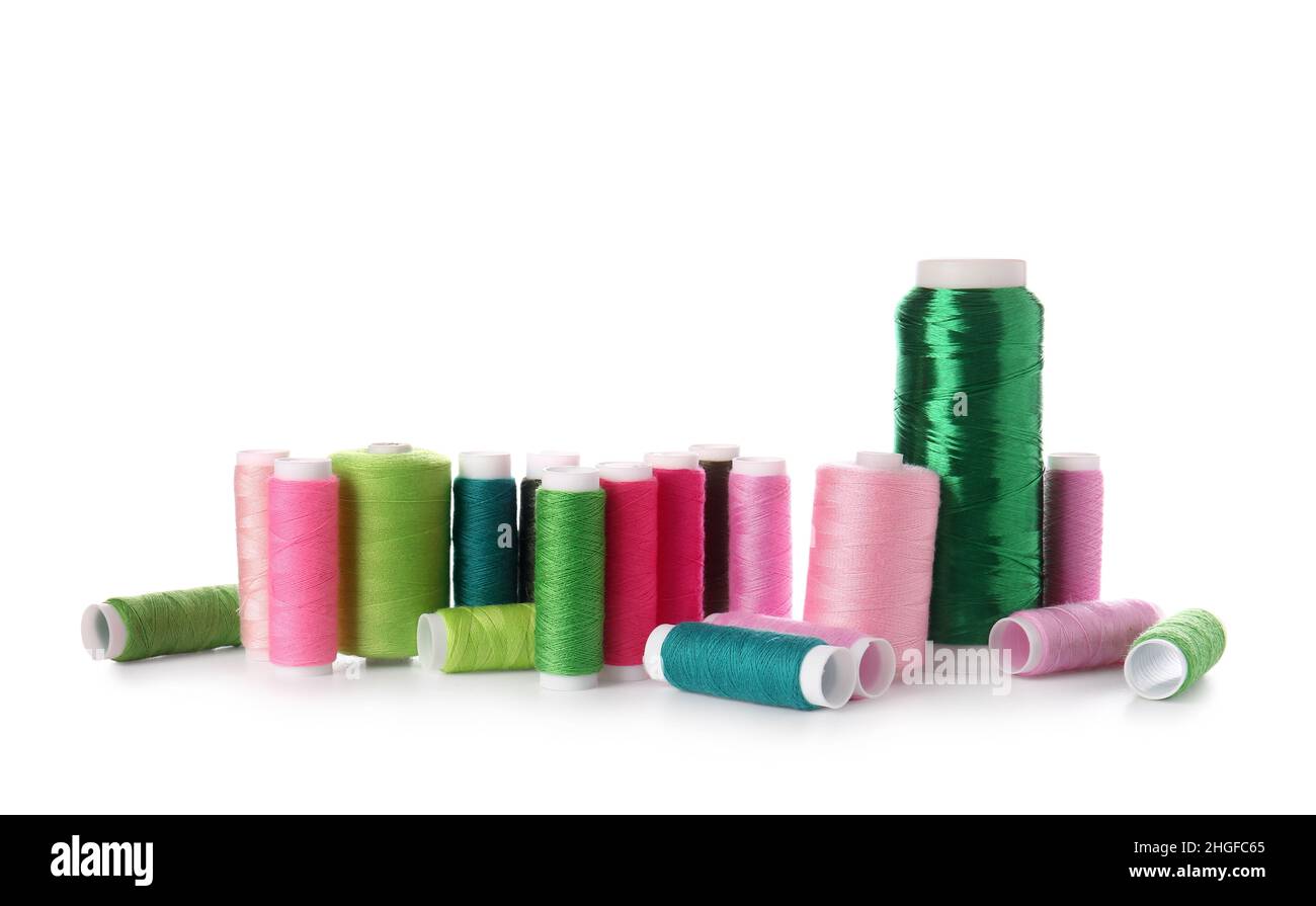 Different sewing thread spools on white background Stock Photo - Alamy