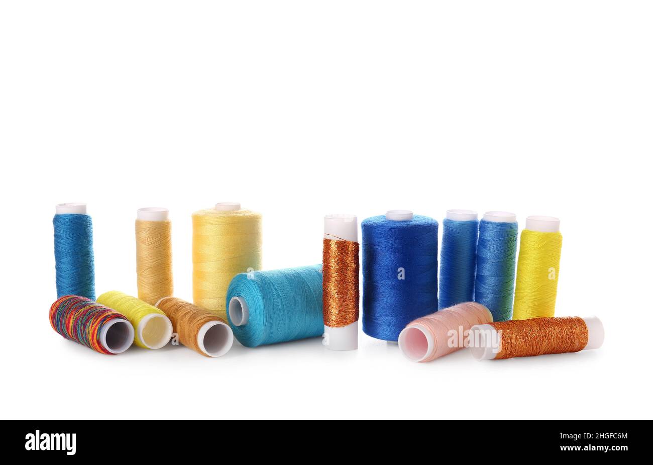 Different sewing thread spools on white background Stock Photo - Alamy