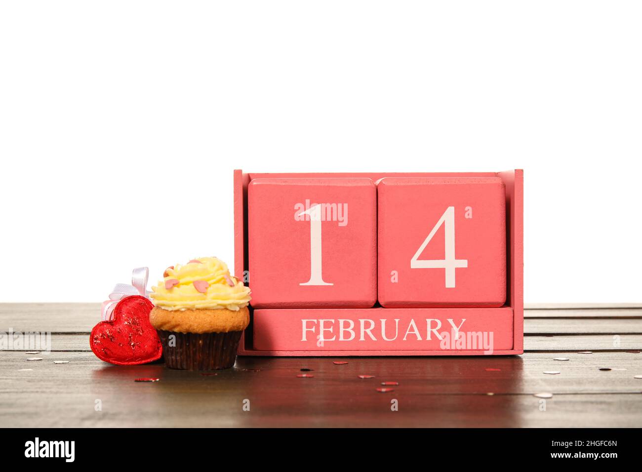 Calendar with date of Valentines Day and tasty cupcake on table against ...