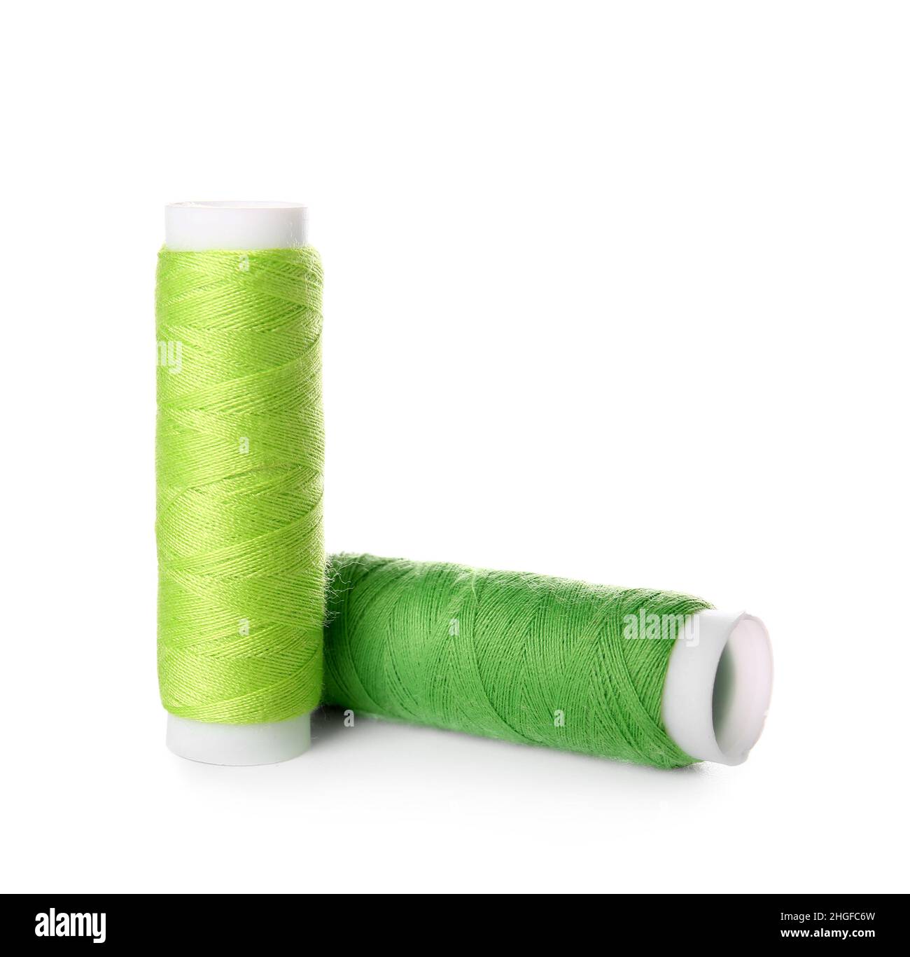 Sewing thread spools on white background Stock Photo - Alamy
