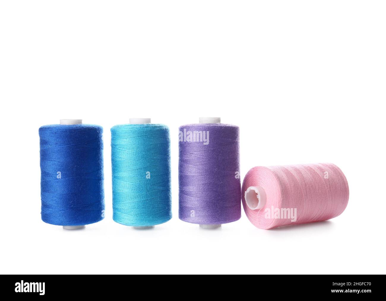 Different sewing thread spools on white background Stock Photo - Alamy