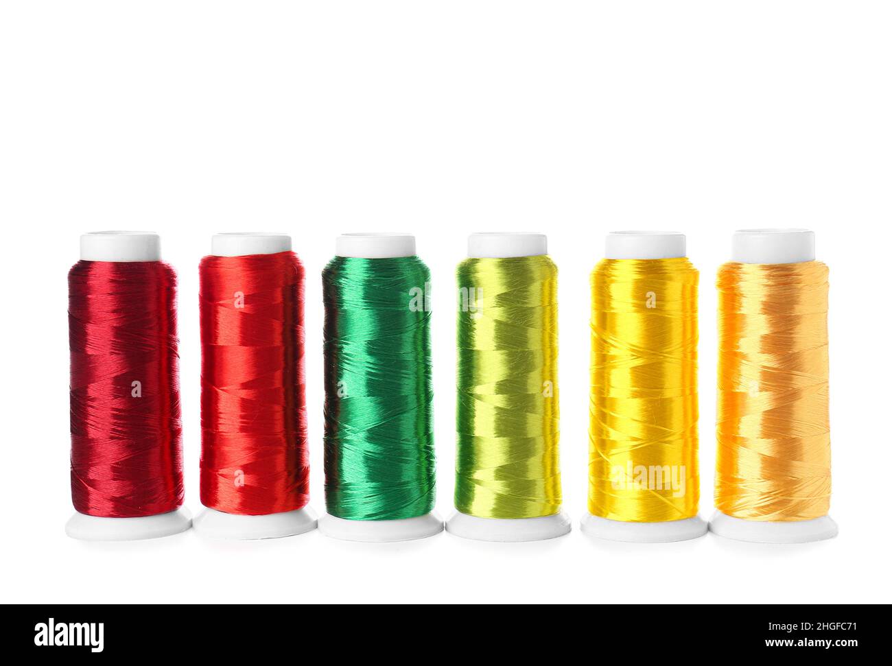 Different sewing thread spools on white background Stock Photo - Alamy