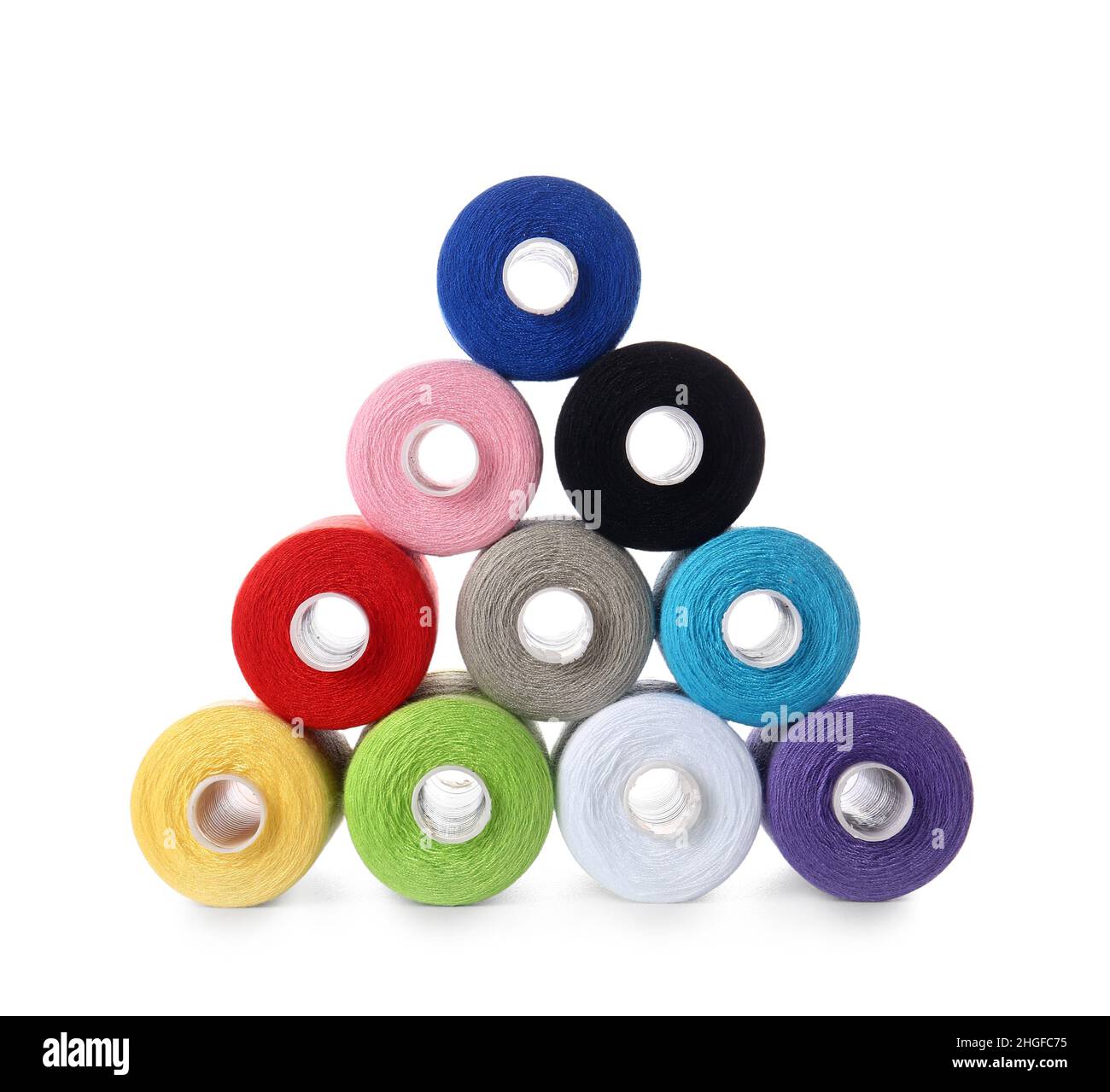 Triangle made of different thread spools on white background Stock ...