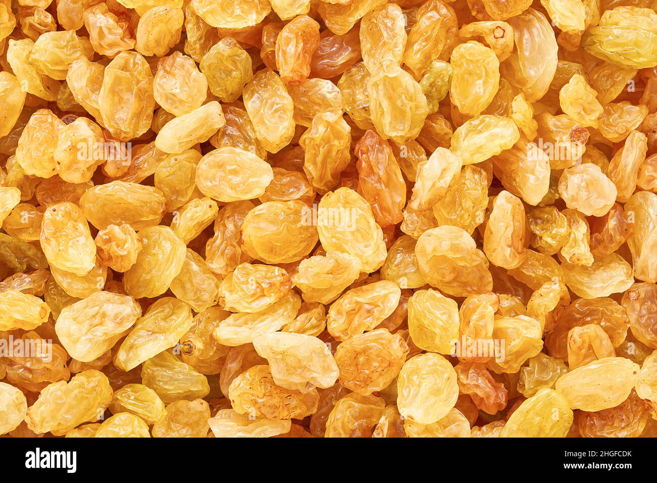 Golden raisins as background. Top view, food background Stock Photo - Alamy
