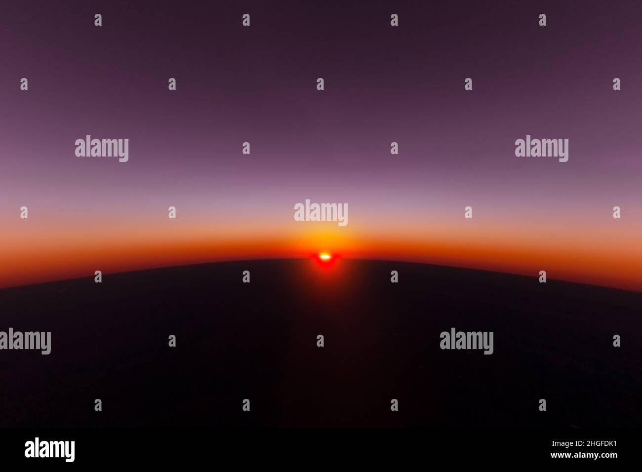 A magical view of the sun setting down at dusk from the window of an ...