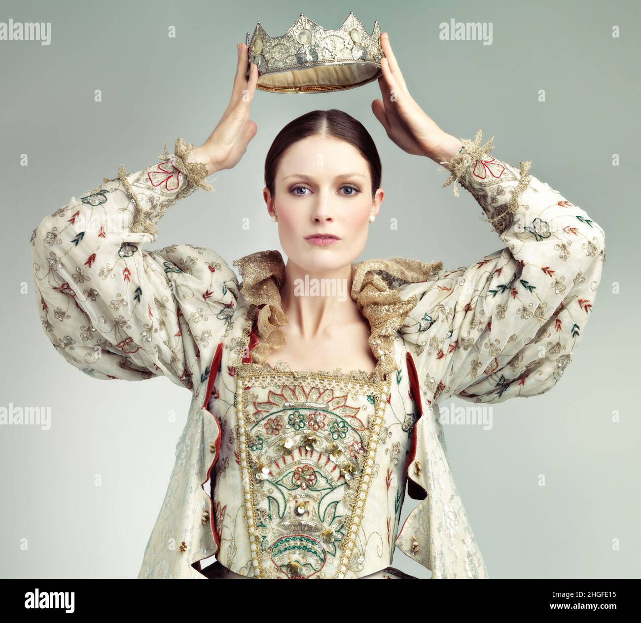 Long live the Queen. Shot of queen holding a crown over her head Stock ...