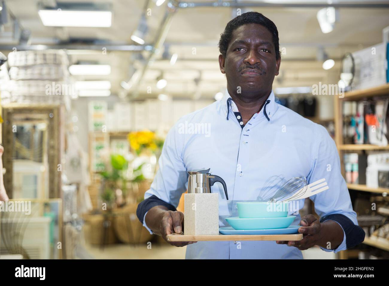 Portrait of man walking through the store with purchases Stock Photo ...