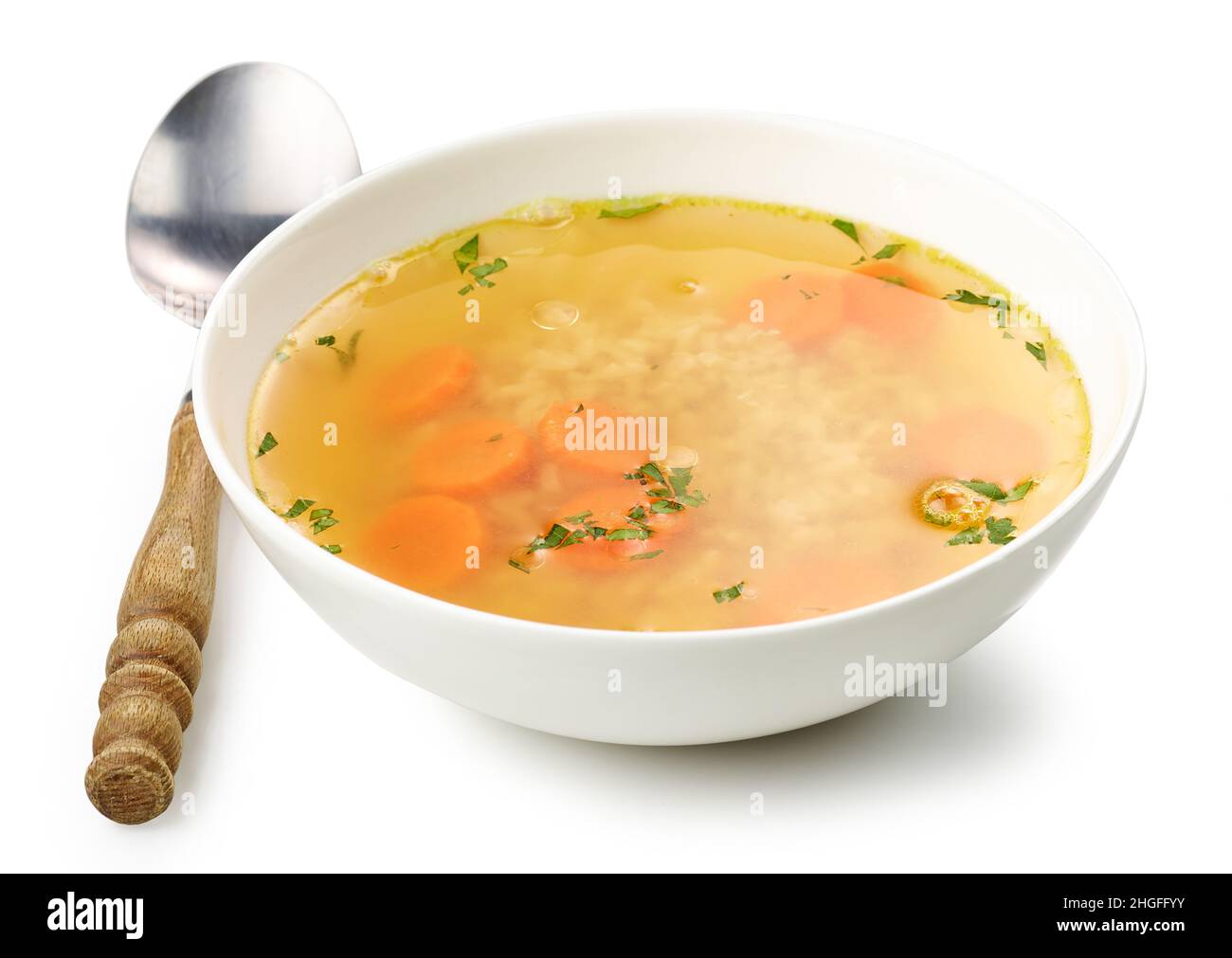 bowl of chicken broth soup with vegetables and rice isolated on white ...
