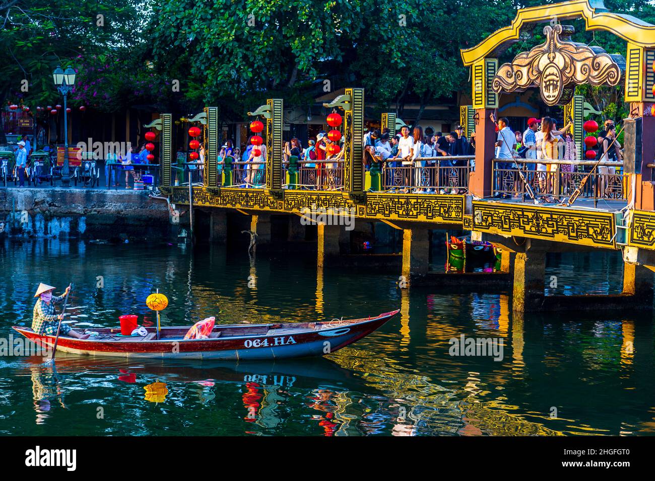 Small tour boat ready to go under the Lantern Bridge with lots of ...