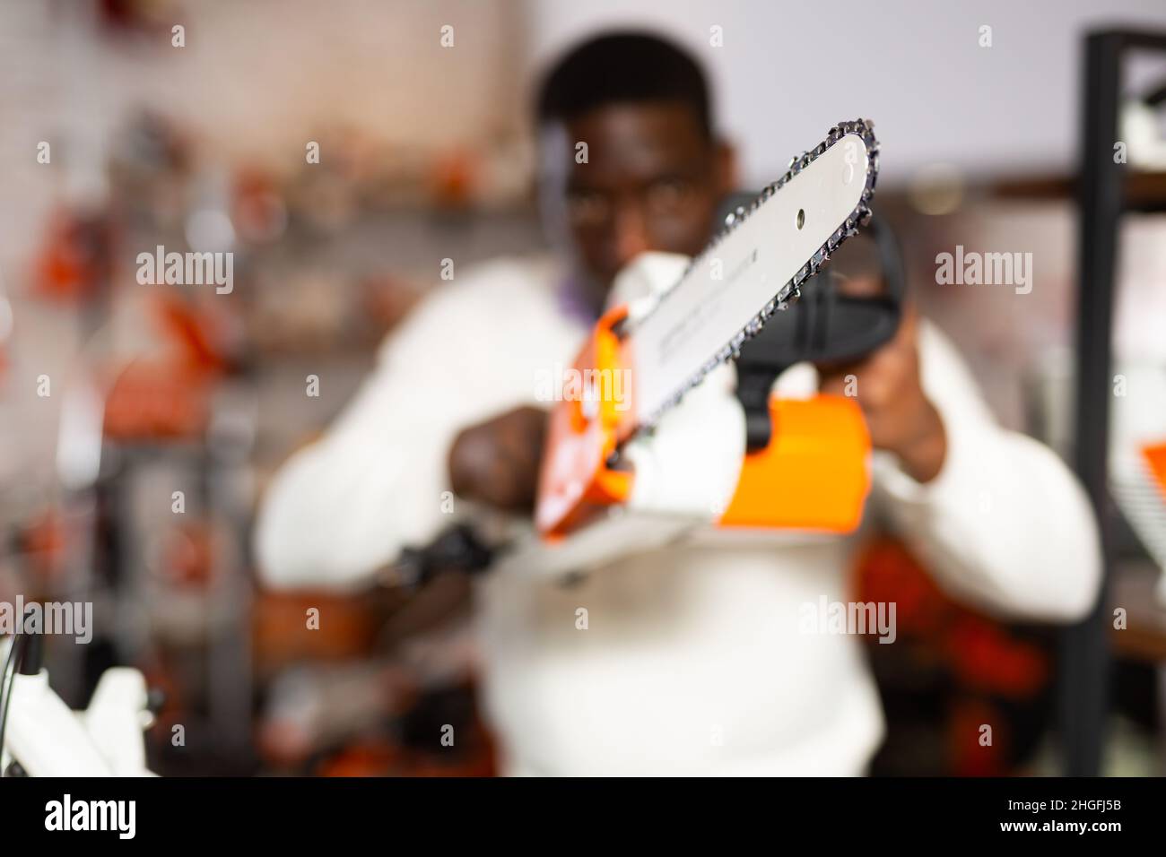 Man holding chainsaw hi-res stock photography and images - Alamy