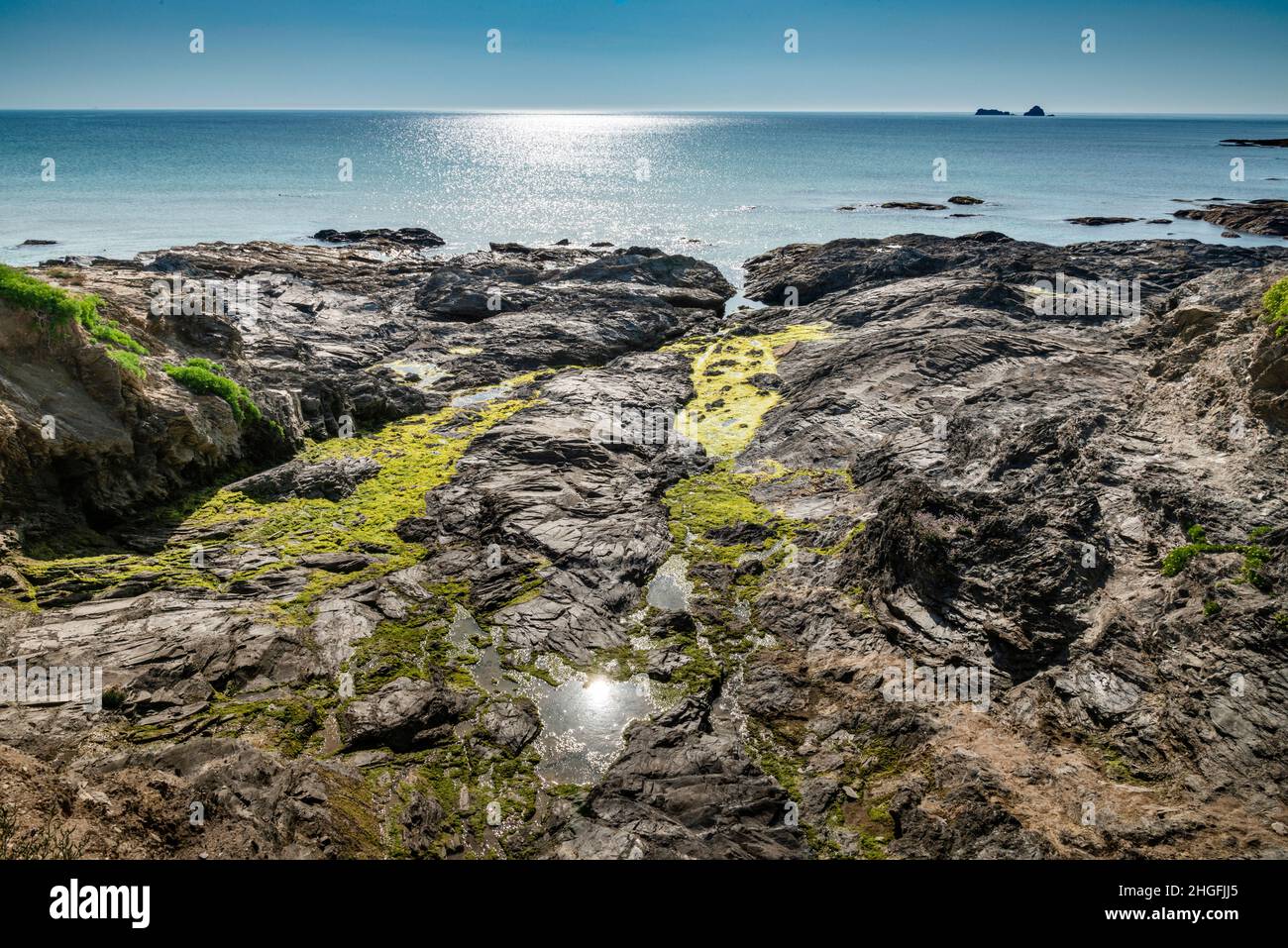 Detailed foreground of ancient ragged granite,slate rocks, strewn along ...