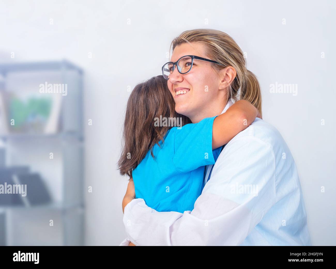Child patient hugging doctor with confidence in office Stock Photo - Alamy