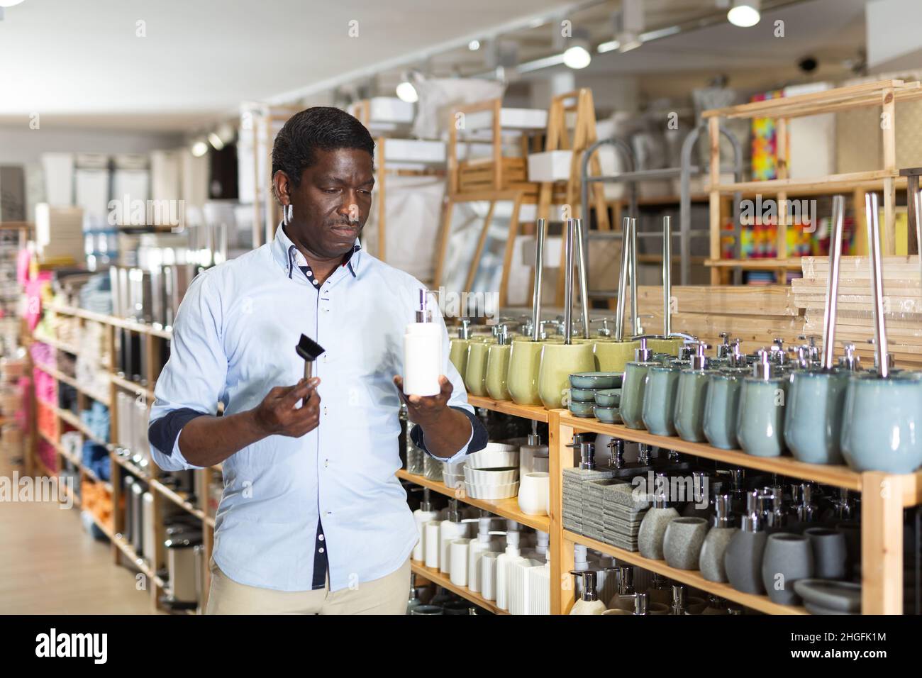 Male shopper chooses toilet brush at hardware store Stock Photo - Alamy