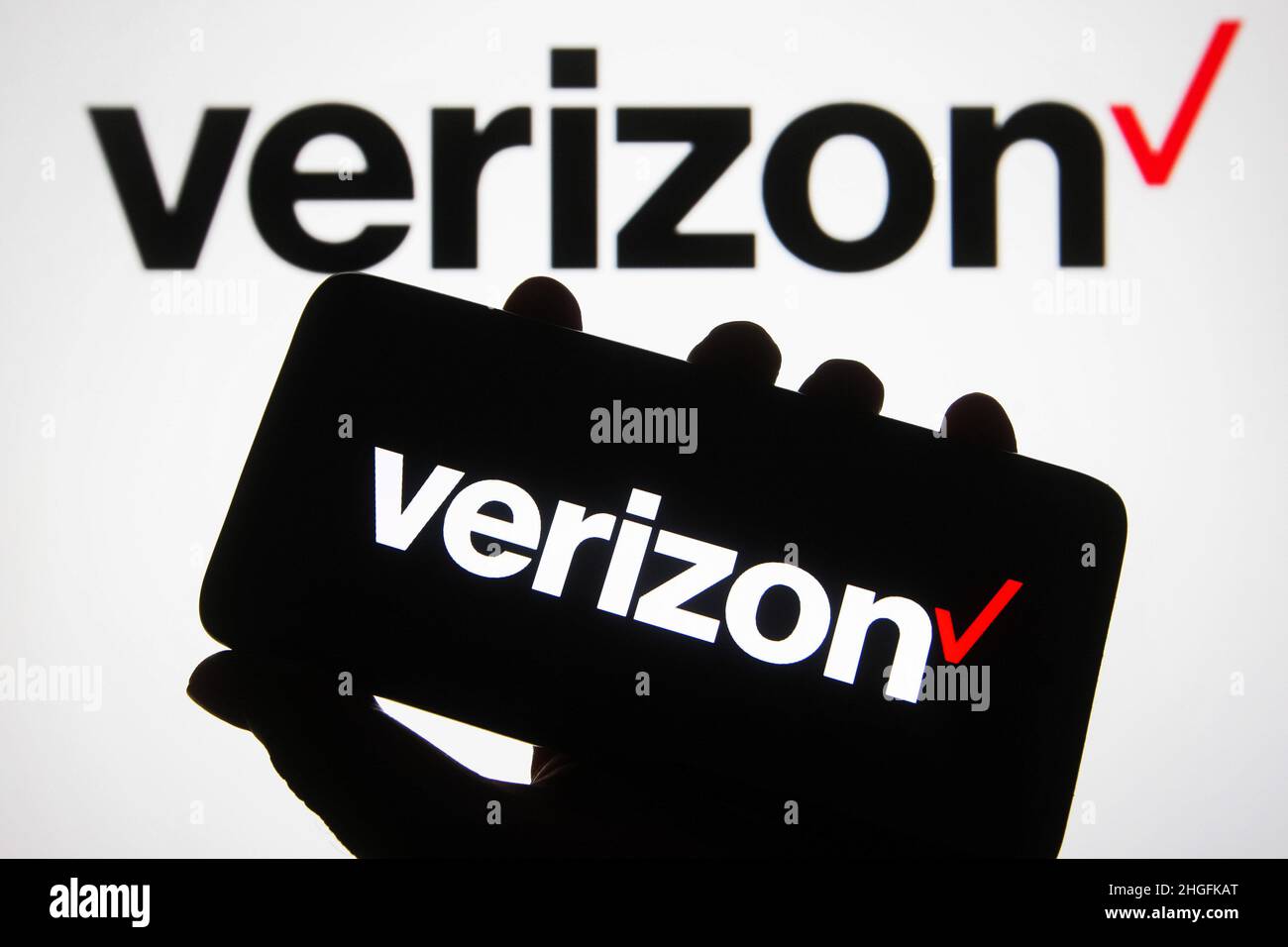 In this photo illustration, a Verizon logo is seen on a smartphone and ...
