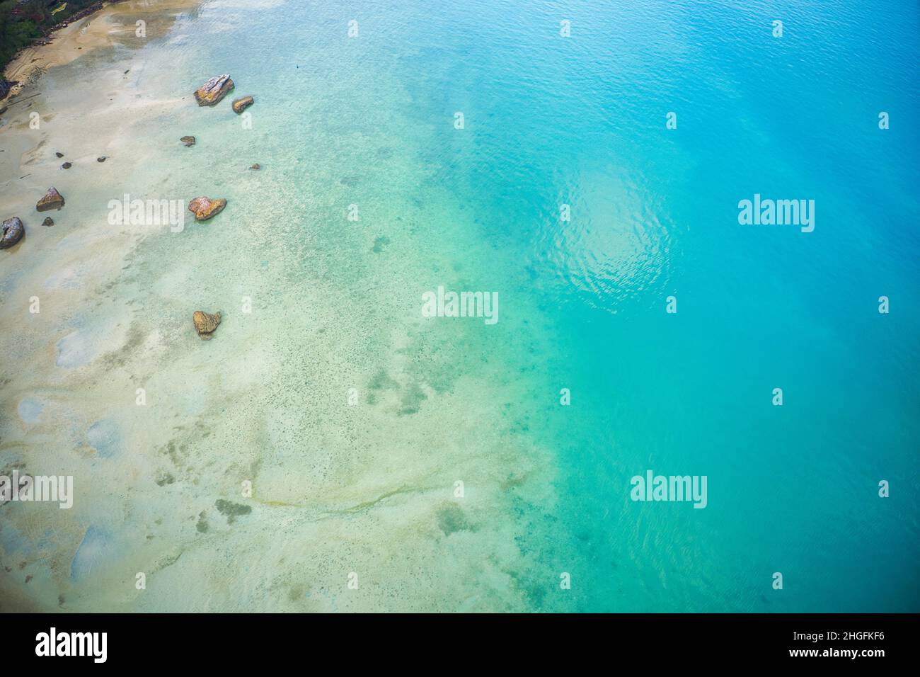 The calm sea with light waves in turquoise photographed from above with a drone. The photo was ...