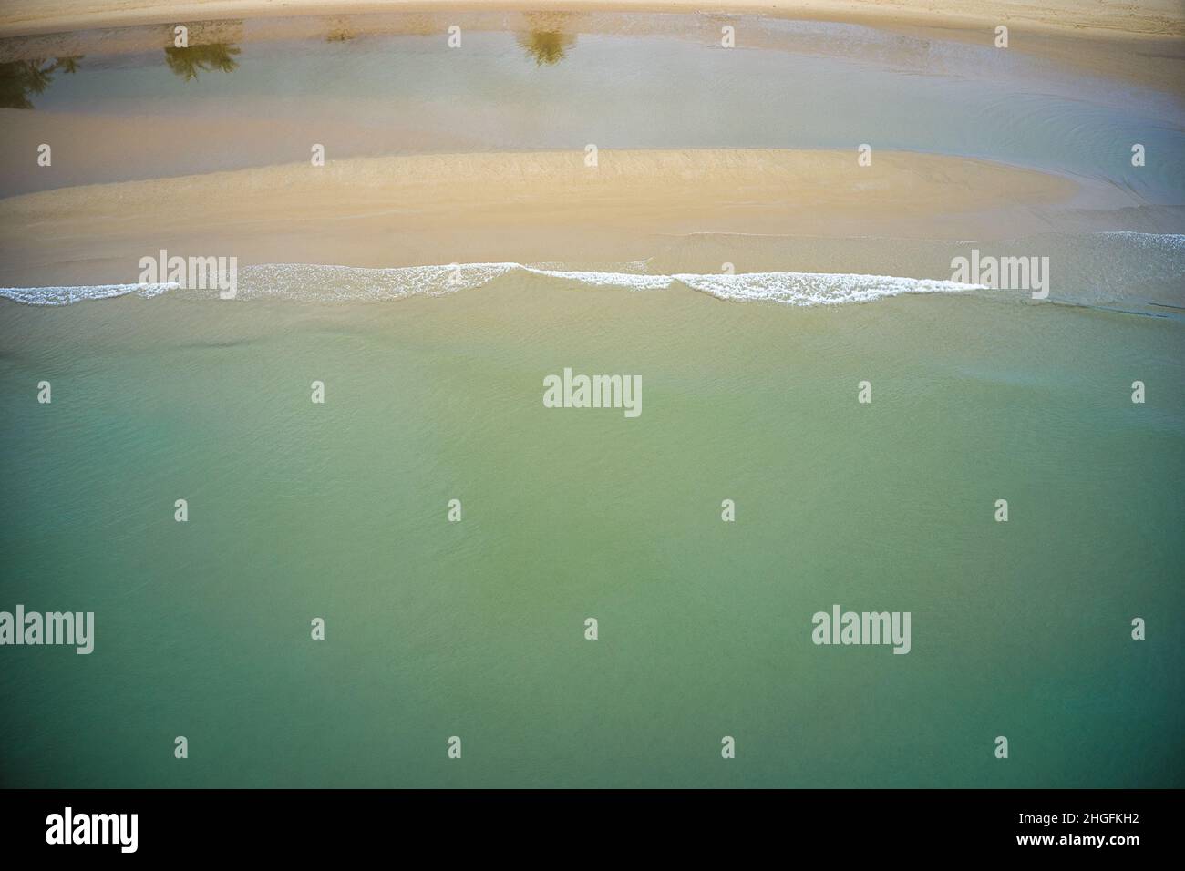 The calm sea with light waves in turquoise photographed from above with ...