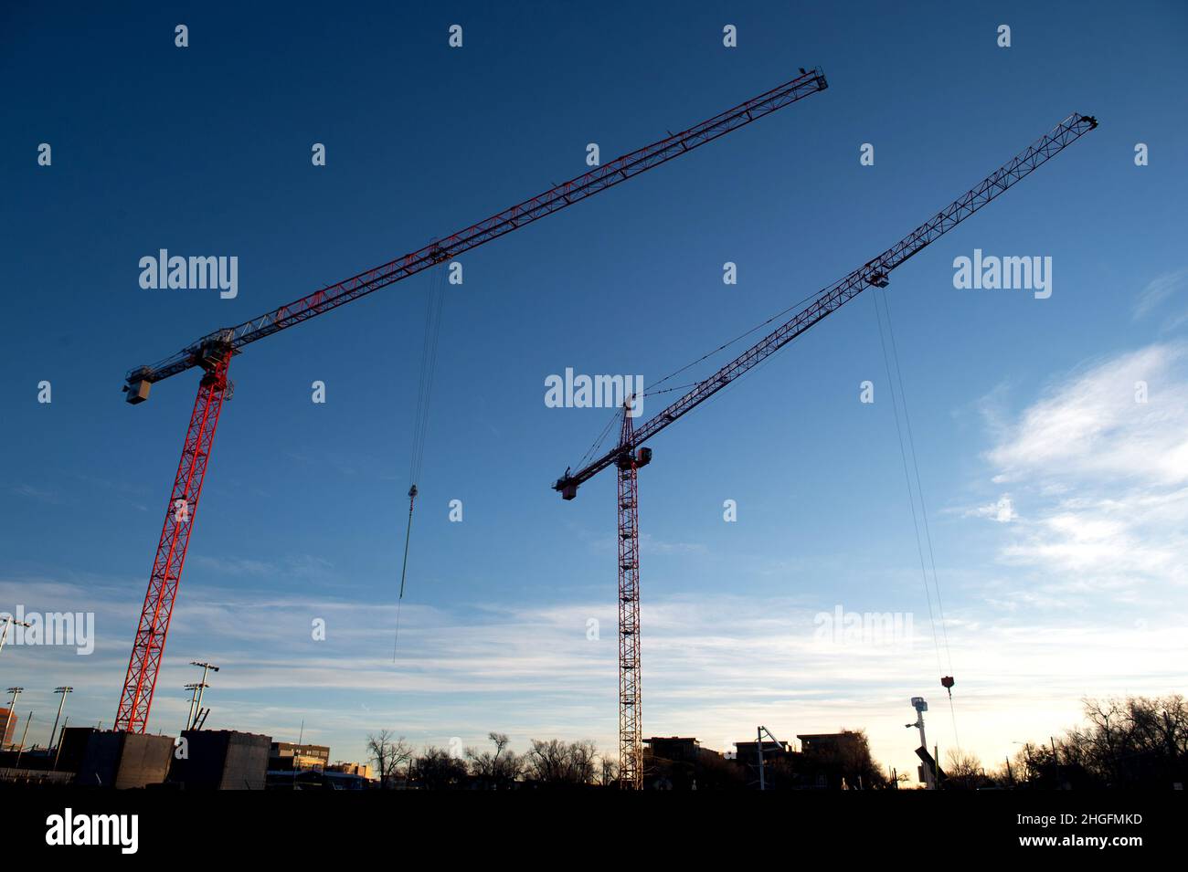 Construction cranes tower over an apartment construction site in ...