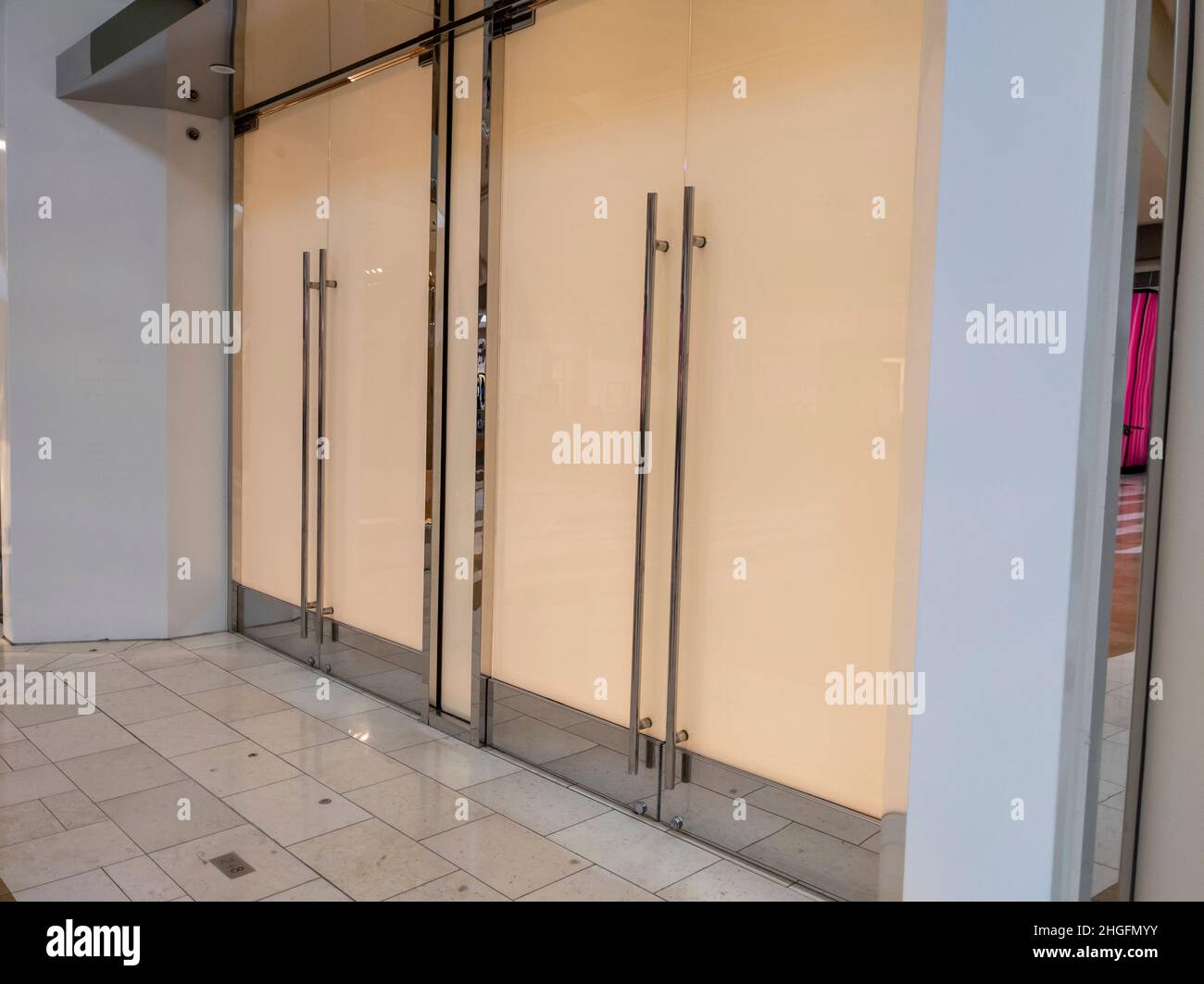 View of the front doors of a business, covered for privacy while the ...