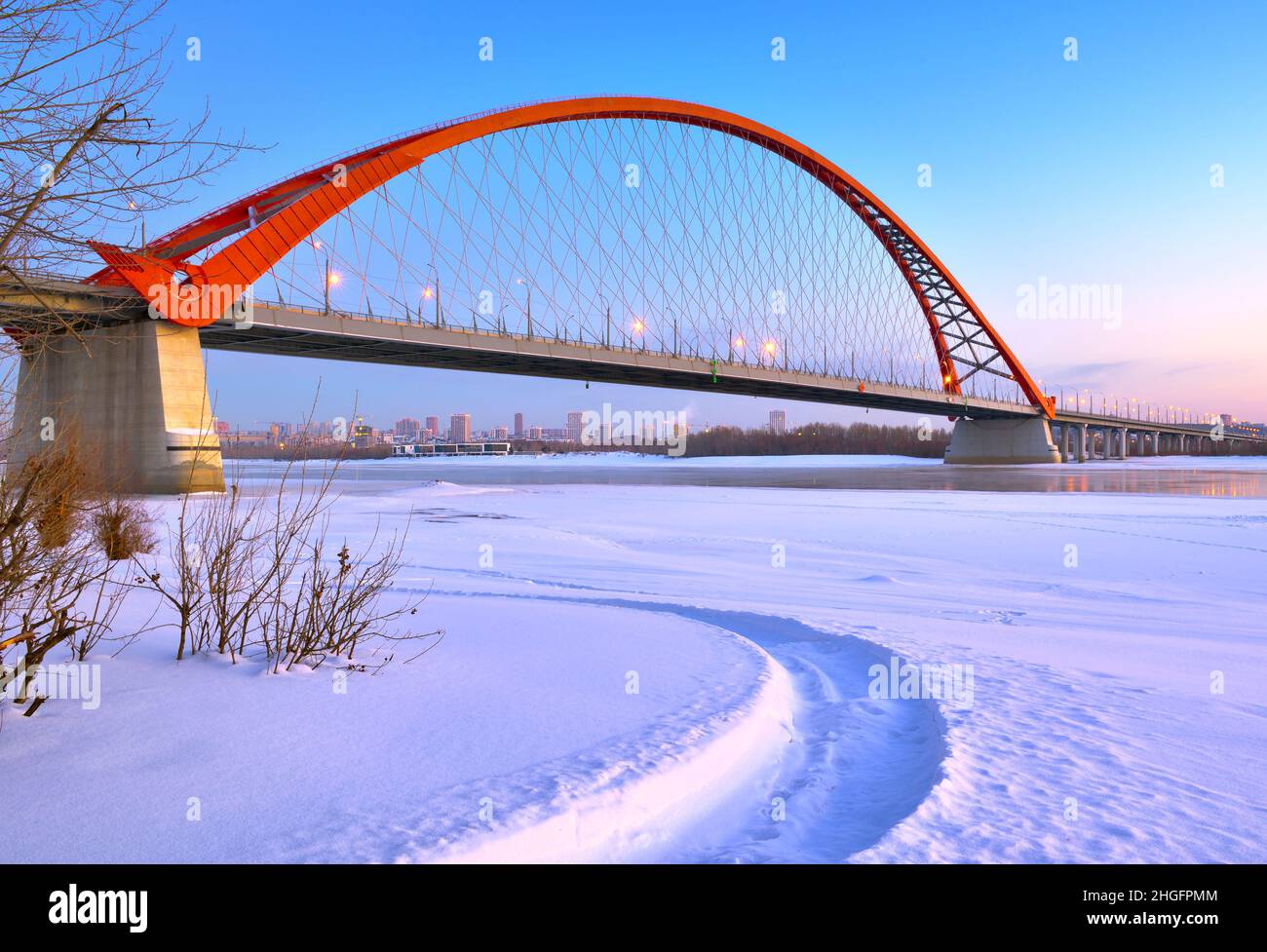 Morning at the Bugrinsky Bridge. Arched bridge with street lights at ...