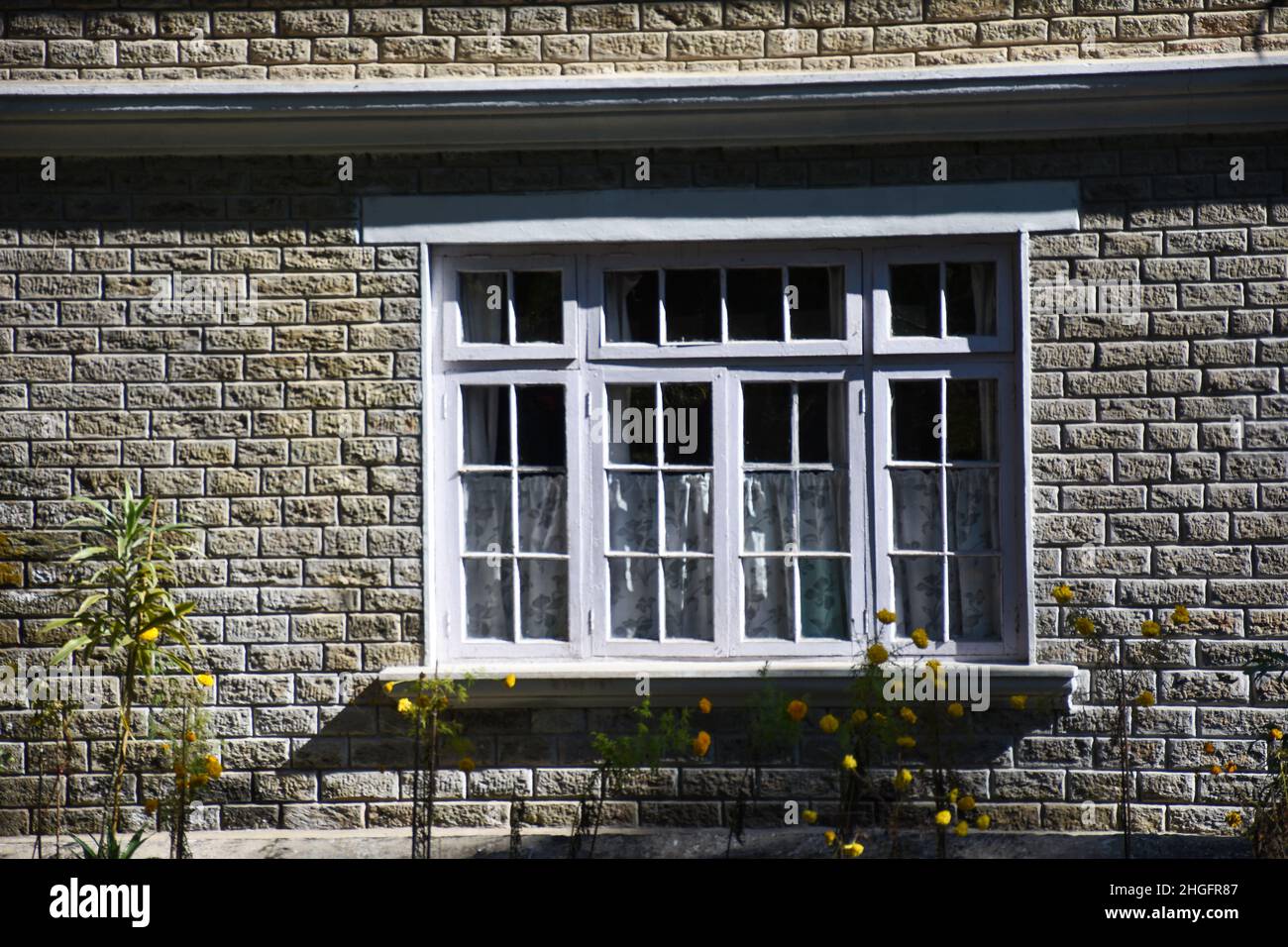 A Beautiful gray Stone House With White Window, garden and flower Stock ...
