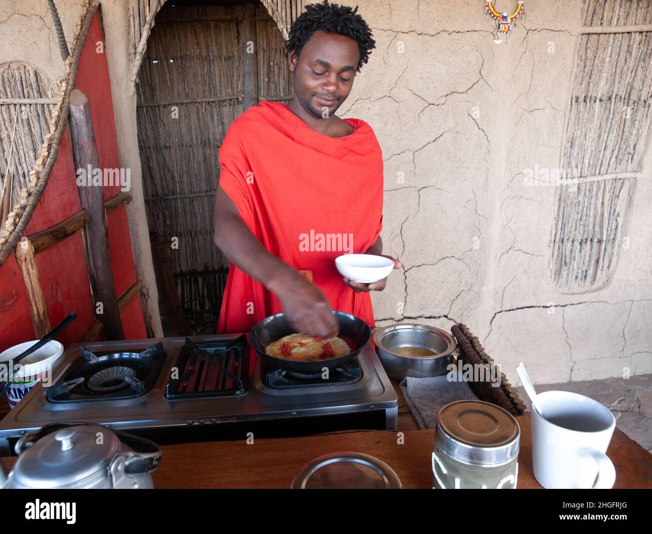 Massai Cook at Maji Moto Eco camp cooking breakfast in an outdoor ...
