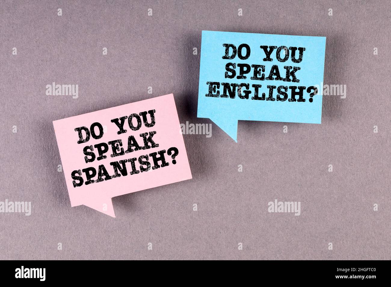 Learn and speak English and Spanish. Two speech bubbles on a gray ...