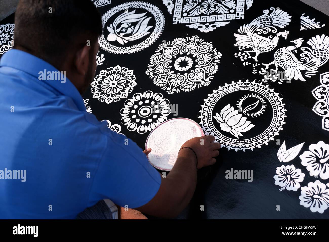 Indian Seller Man making rangoli from design patterns of Rangoli with ...