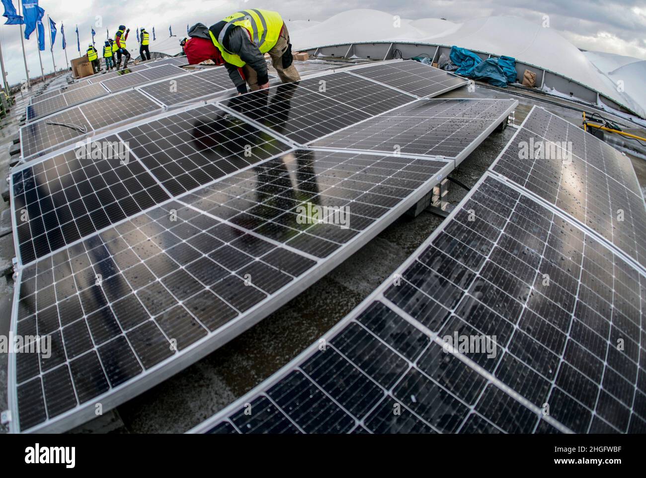 Berlin, Germany. 20th Jan, 2022. Workers install solar modules of a new ...