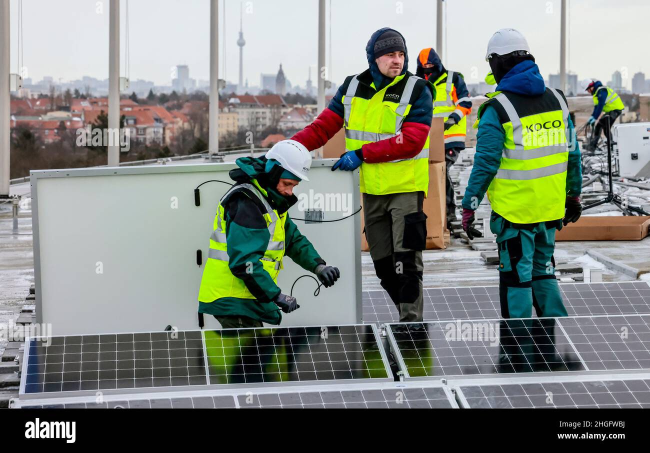 Berlin, Germany. 20th Jan, 2022. Workers install solar modules of a new ...