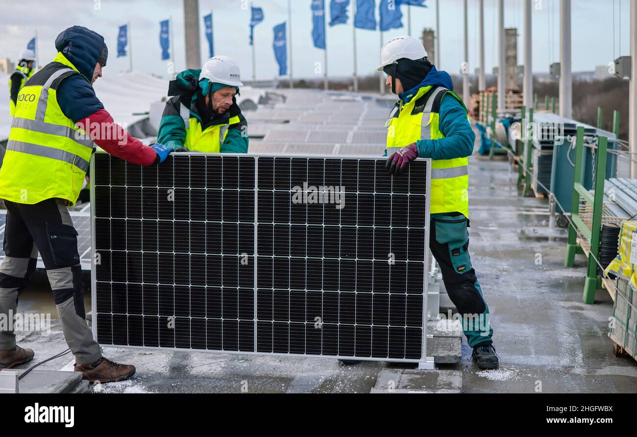 Berlin, Germany. 20th Jan, 2022. Workers install solar modules of a new ...