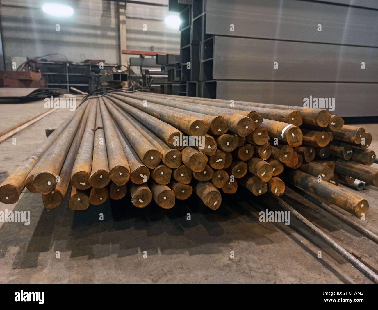 Warehousing in the workshop at the plant stock of metal rods. Industry ...
