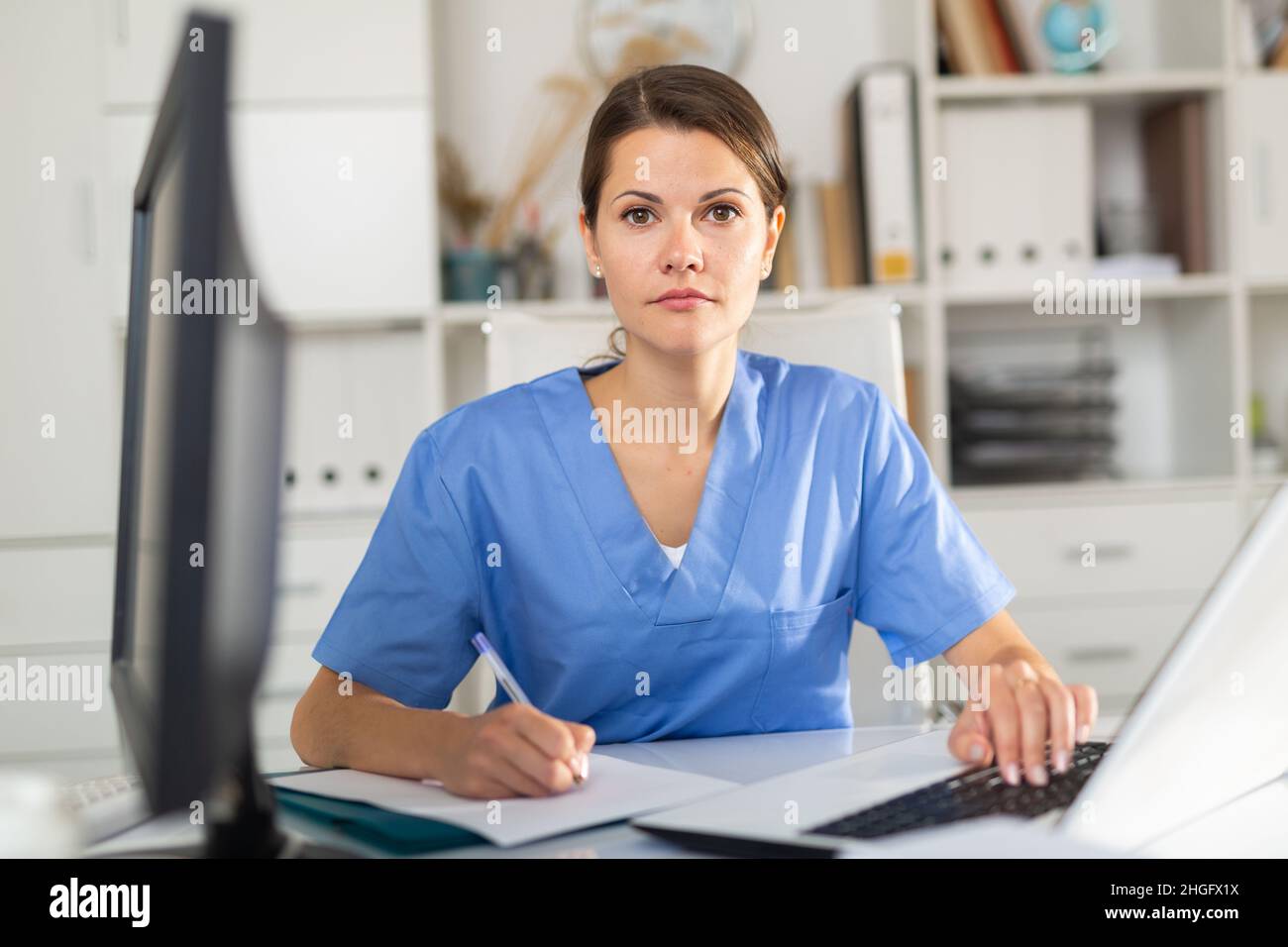 Focused woman physician listening to patient complaints at clinic Stock ...