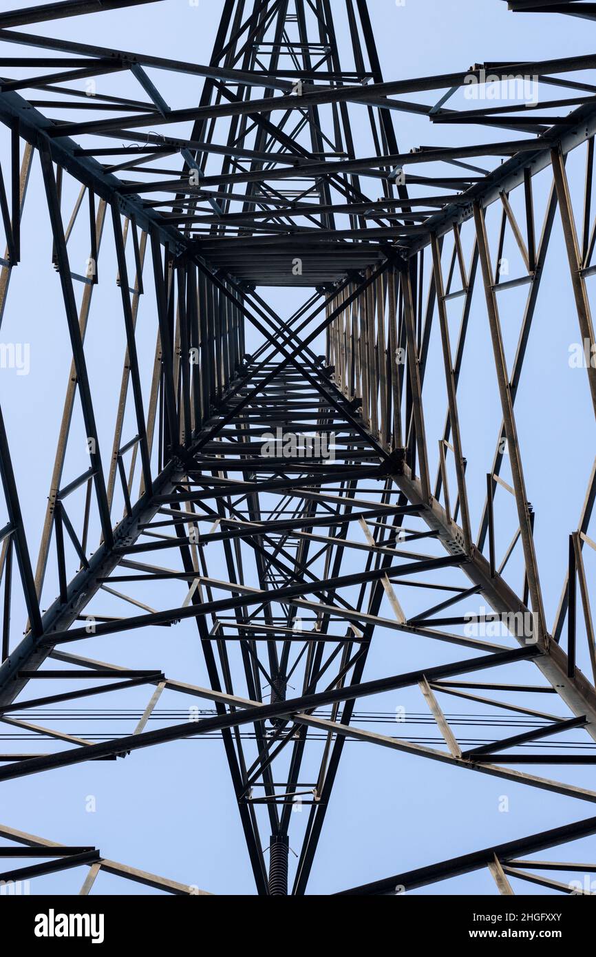 Close up bottom view of high voltage electricity transmission tower ...
