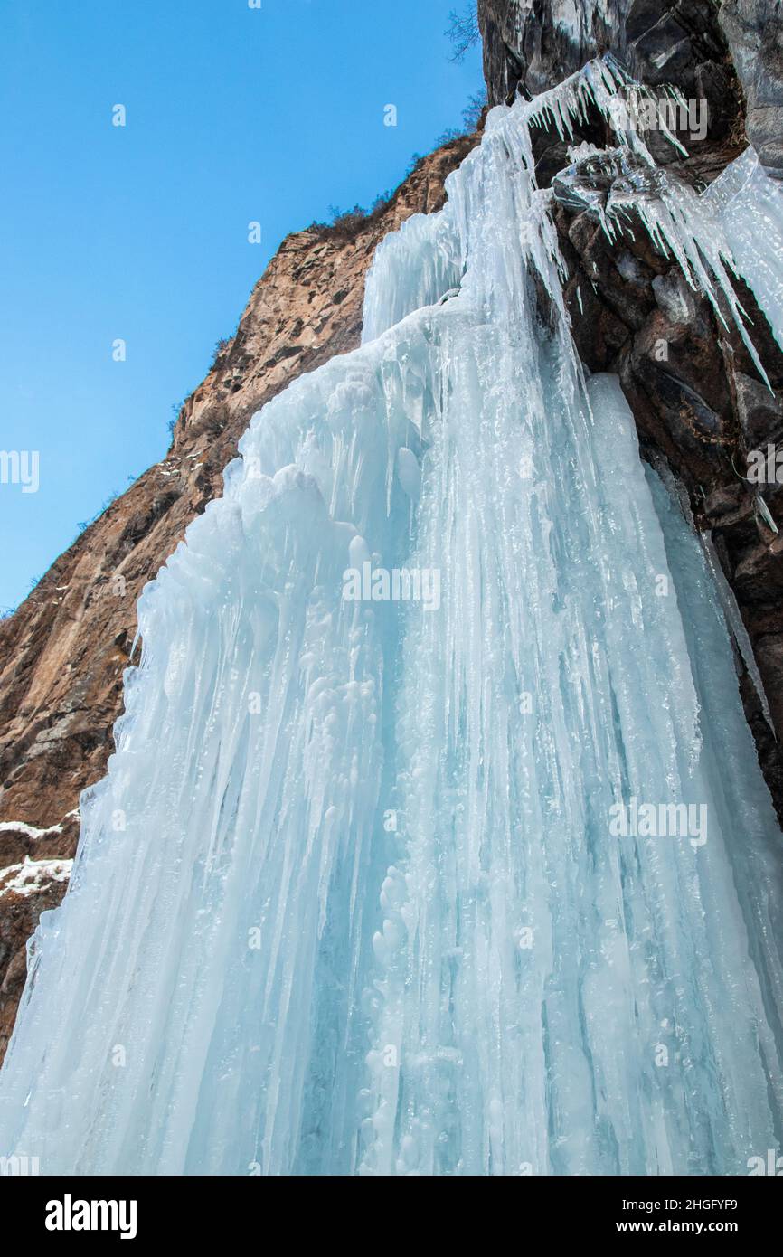 Frozen waterfall on rocky mountain in winter day in Almaty region Stock ...
