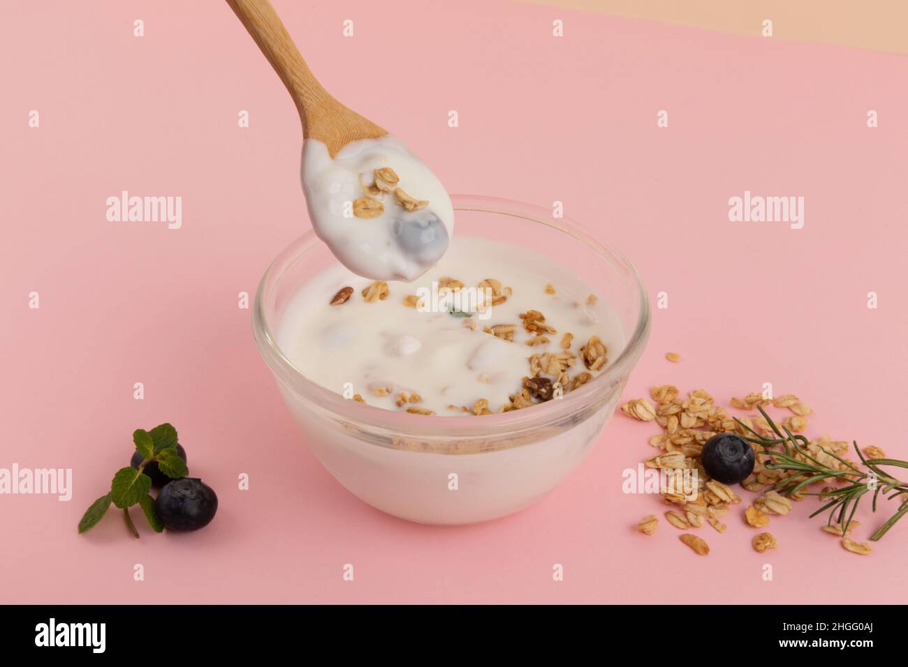 scooping yogurt with a spoon, pink background Stock Photo - Alamy