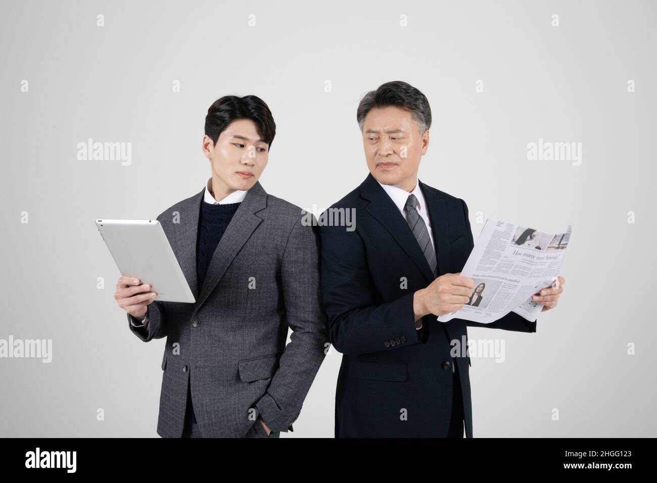 Two young men reading a newspaper hi-res stock photography and images ...