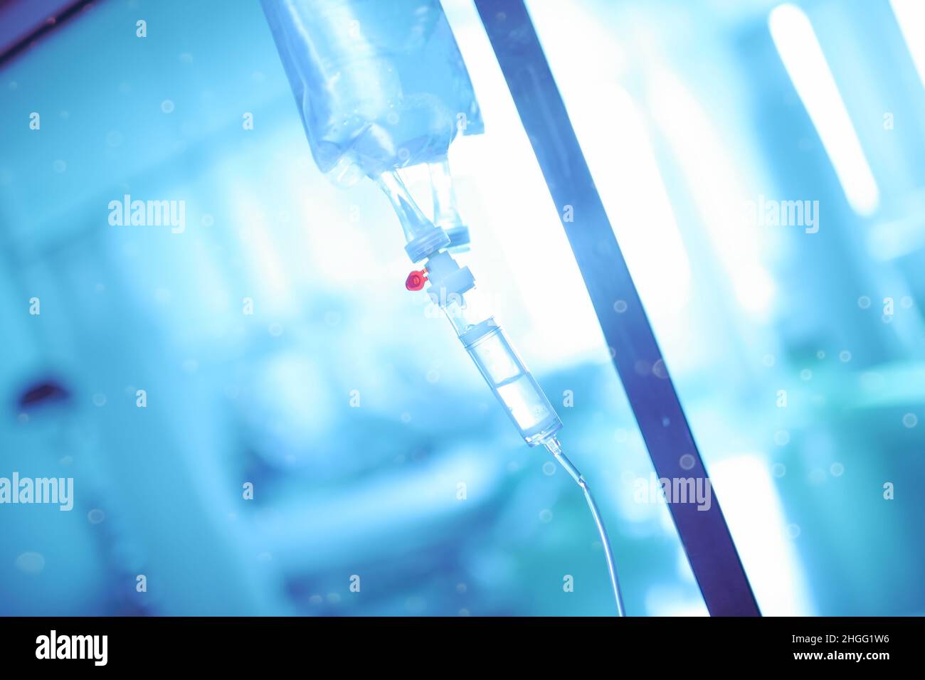 Intravenous drip bag in front of the light from the hospital window ...