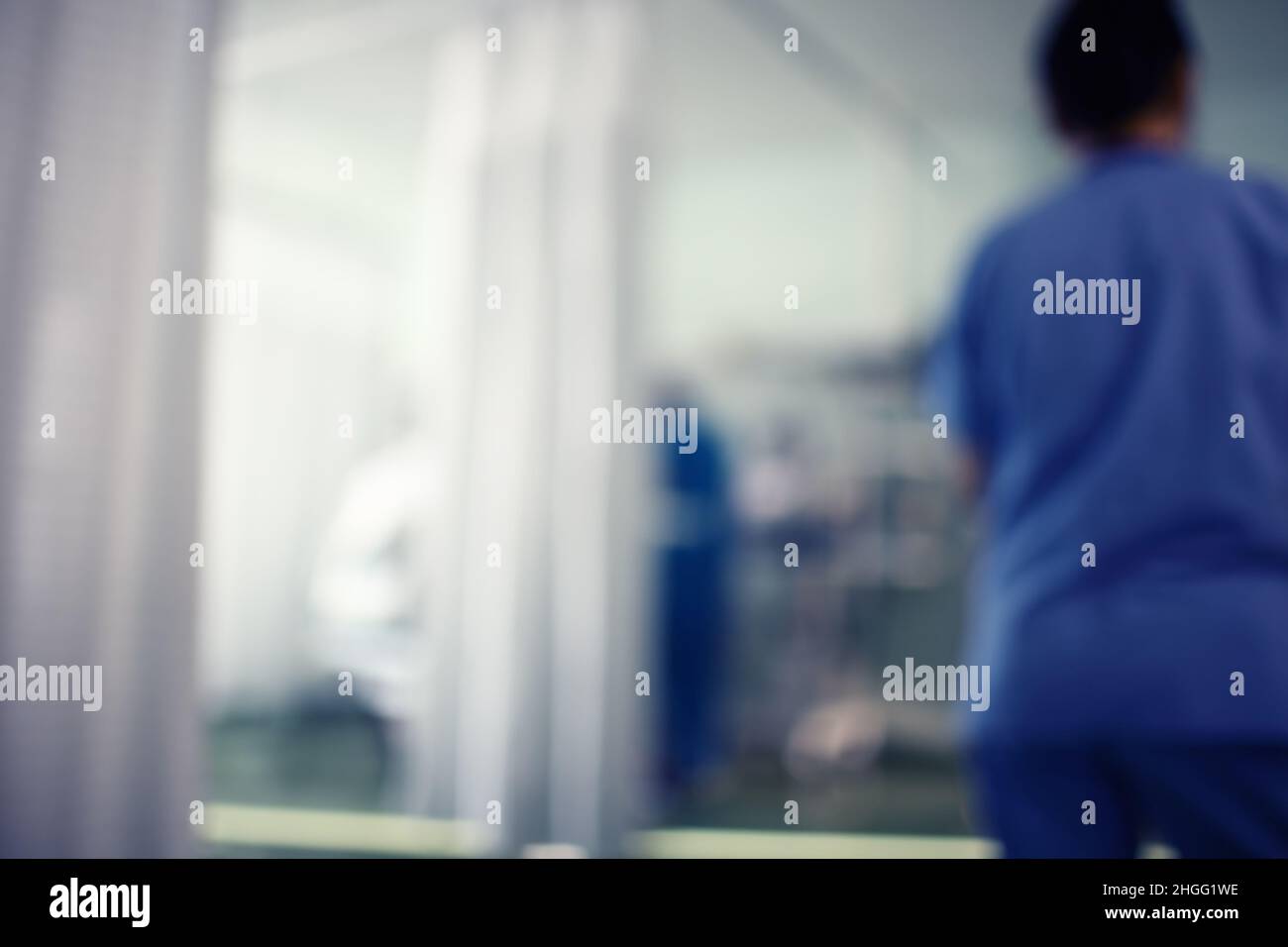 Unfocused background with figures of working medical personnel in the ...